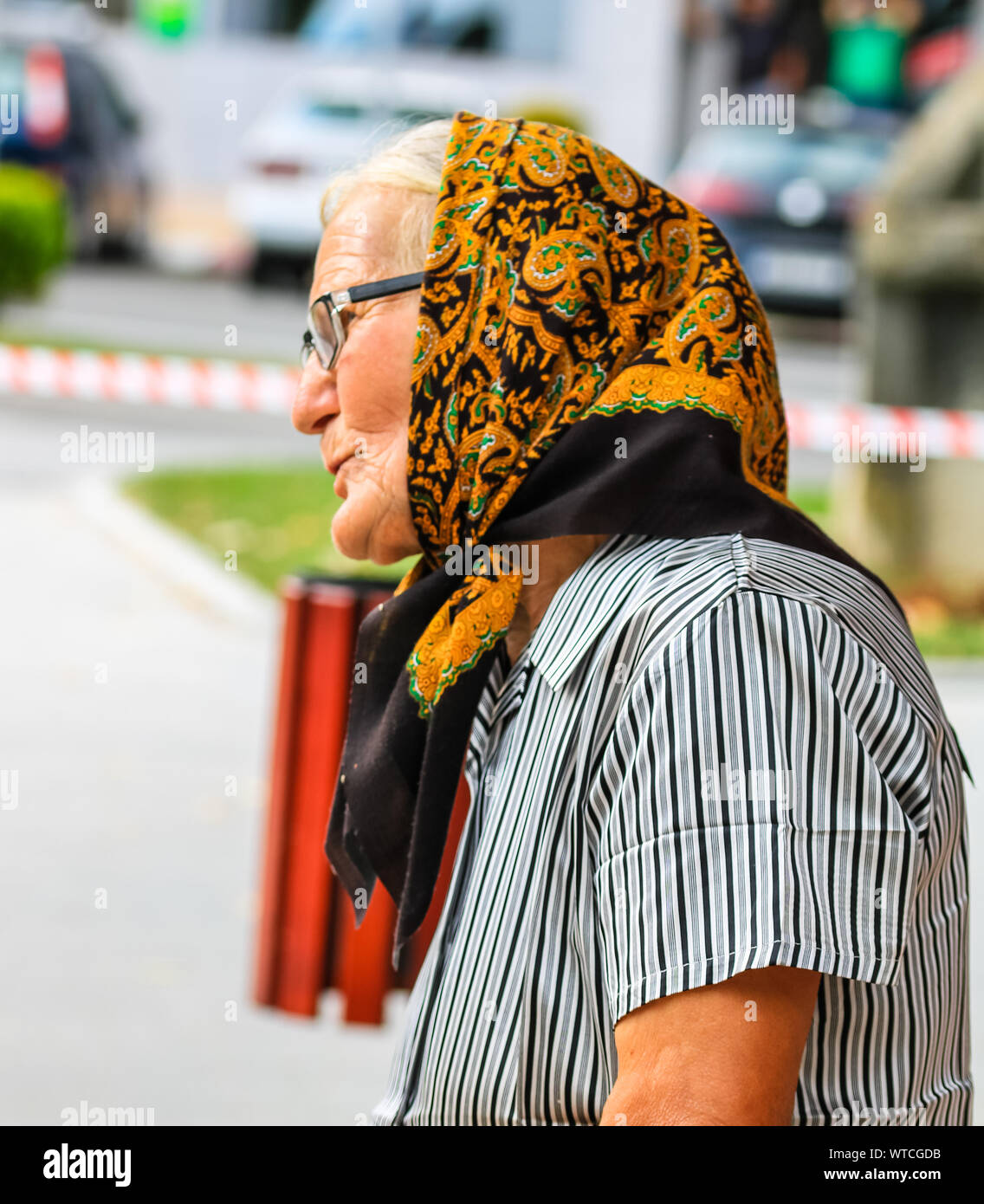 Portrait of an old lady with traditional Romania head scarf in ...