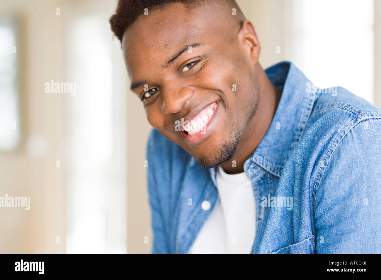 Handsome african young man smiling cheerful with a big smile on face ...