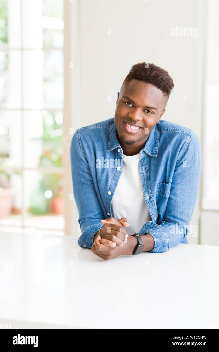 Handsome african young man smiling cheerful with a big smile on face ...