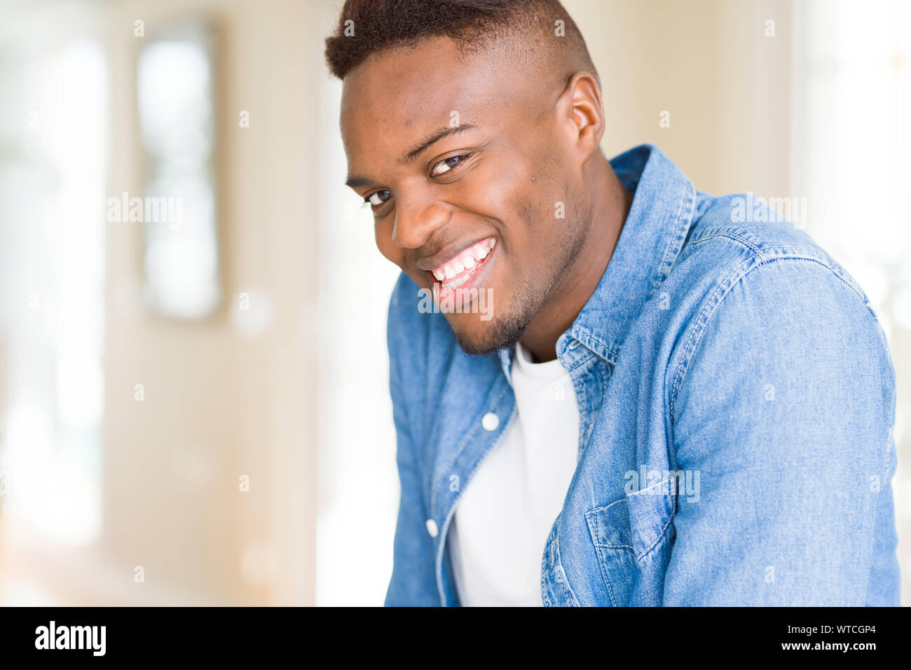Handsome african young man smiling cheerful with a big smile on face ...