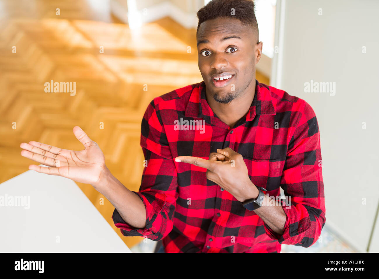 Overhead angle of handsome african american man amazed and smiling to ...