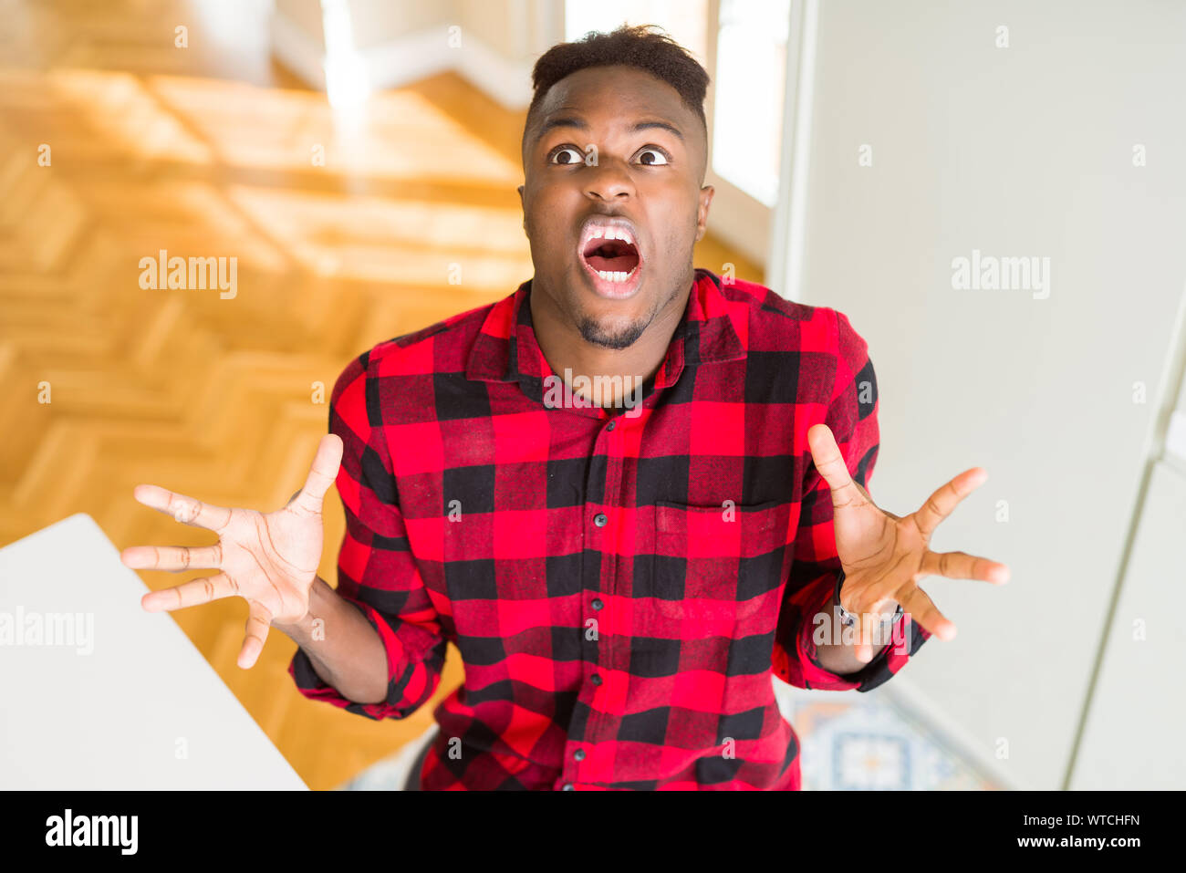 Overhead angle of handsome african american man celebrating mad and ...