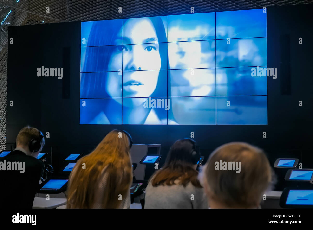 Group of students watching video presentation about tolerance on large ...