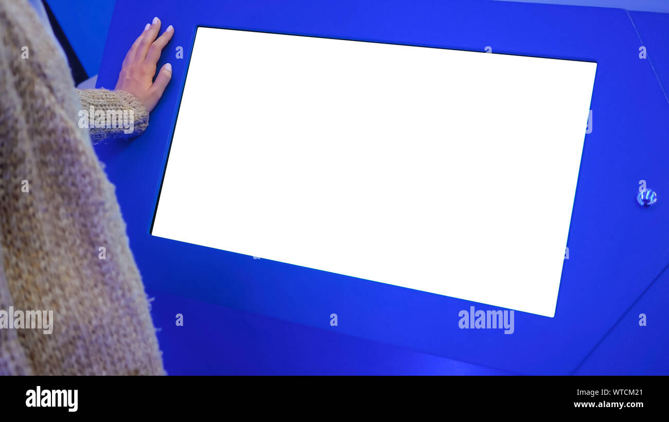 White screen concept - woman looking at blank white display kiosk at ...