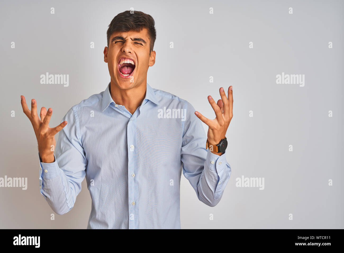 Young indian businessman wearing elegant shirt standing over isolated ...