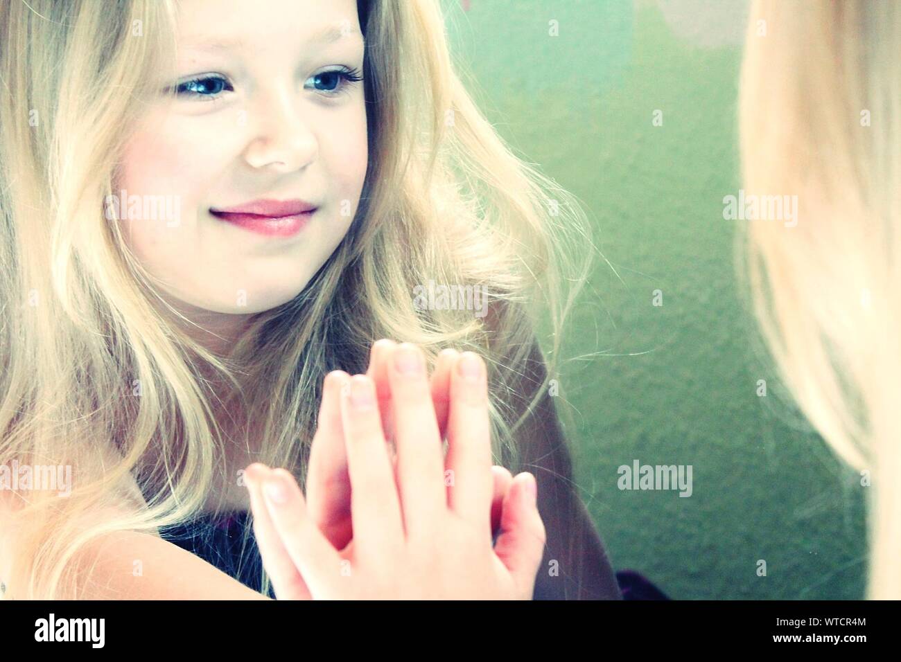 Person looking at reflection in mirror hi-res stock photography and ...