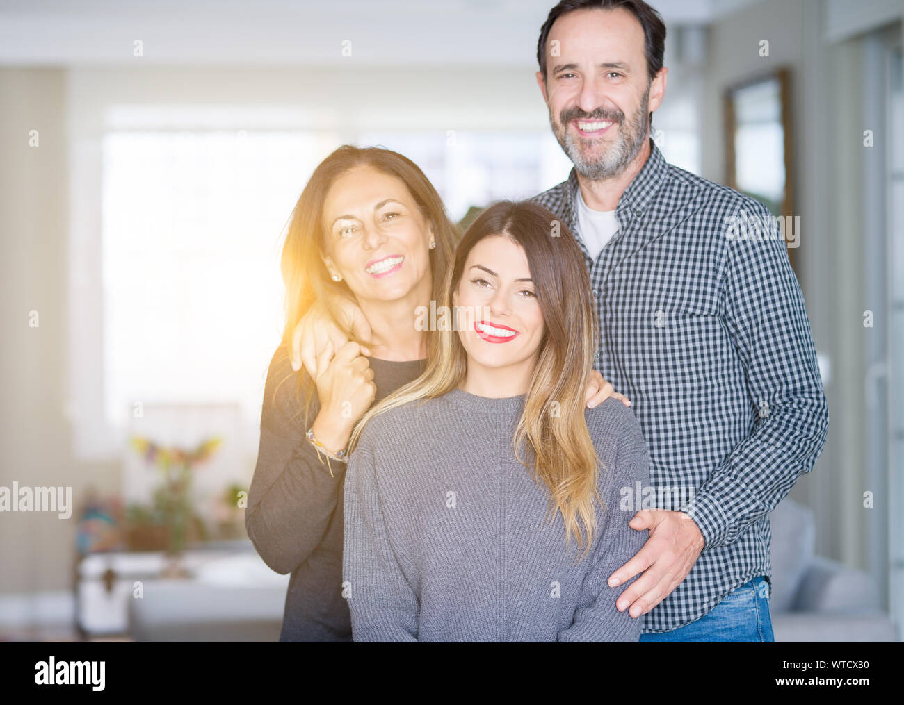 Beautiful family together. Mother, father and daughter smiling and ...