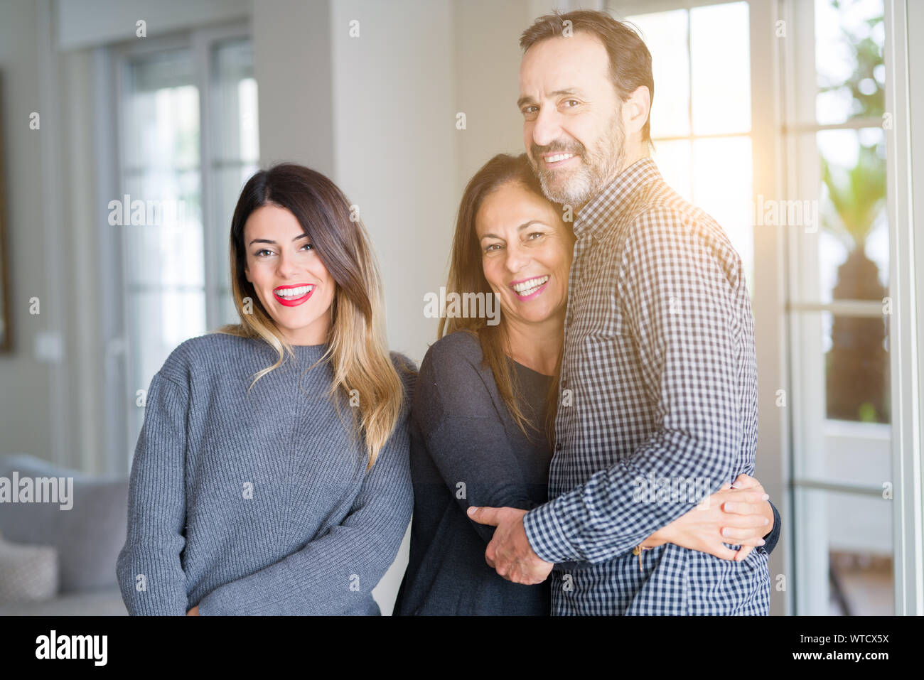 Beautiful family together. Mother, father and daughter smiling and ...