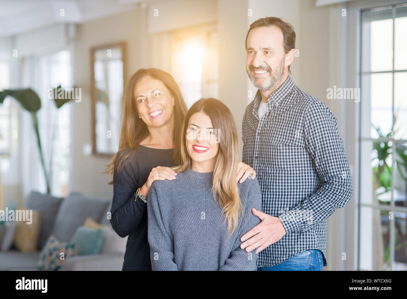 Beautiful family together. Mother, father and daughter smiling and ...