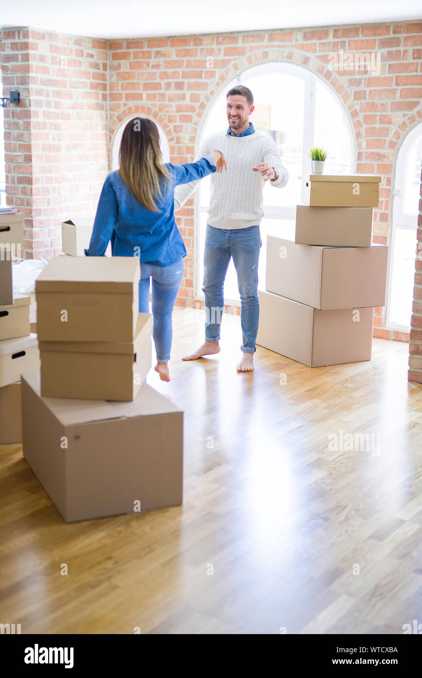 Young beautiful couple dancing at new home around cardboard boxes Stock ...