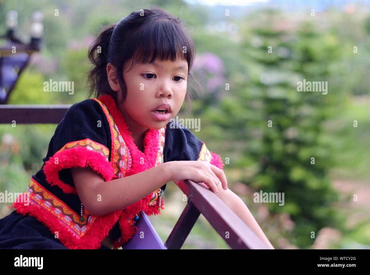 Girl standing railing balcony hi-res stock photography and images - Alamy