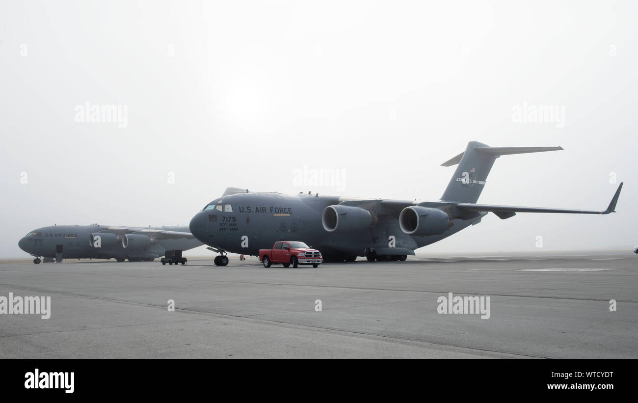 Two U.S. Air Force C-17 Globemaster IIIs rest on the flightline during ...
