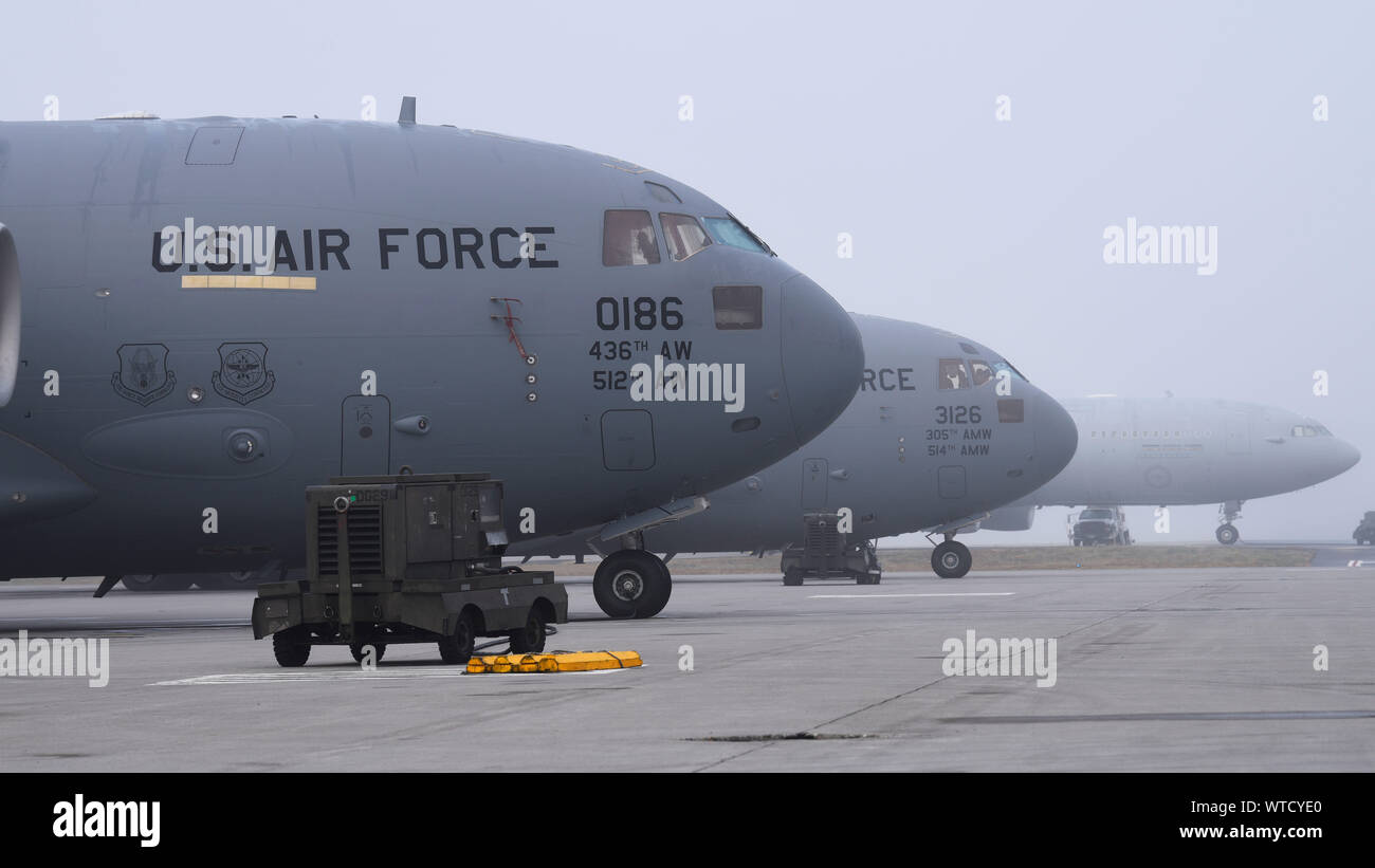 Two U.S. Air Force C-17 Globemaster IIIs rest on the flightline during ...
