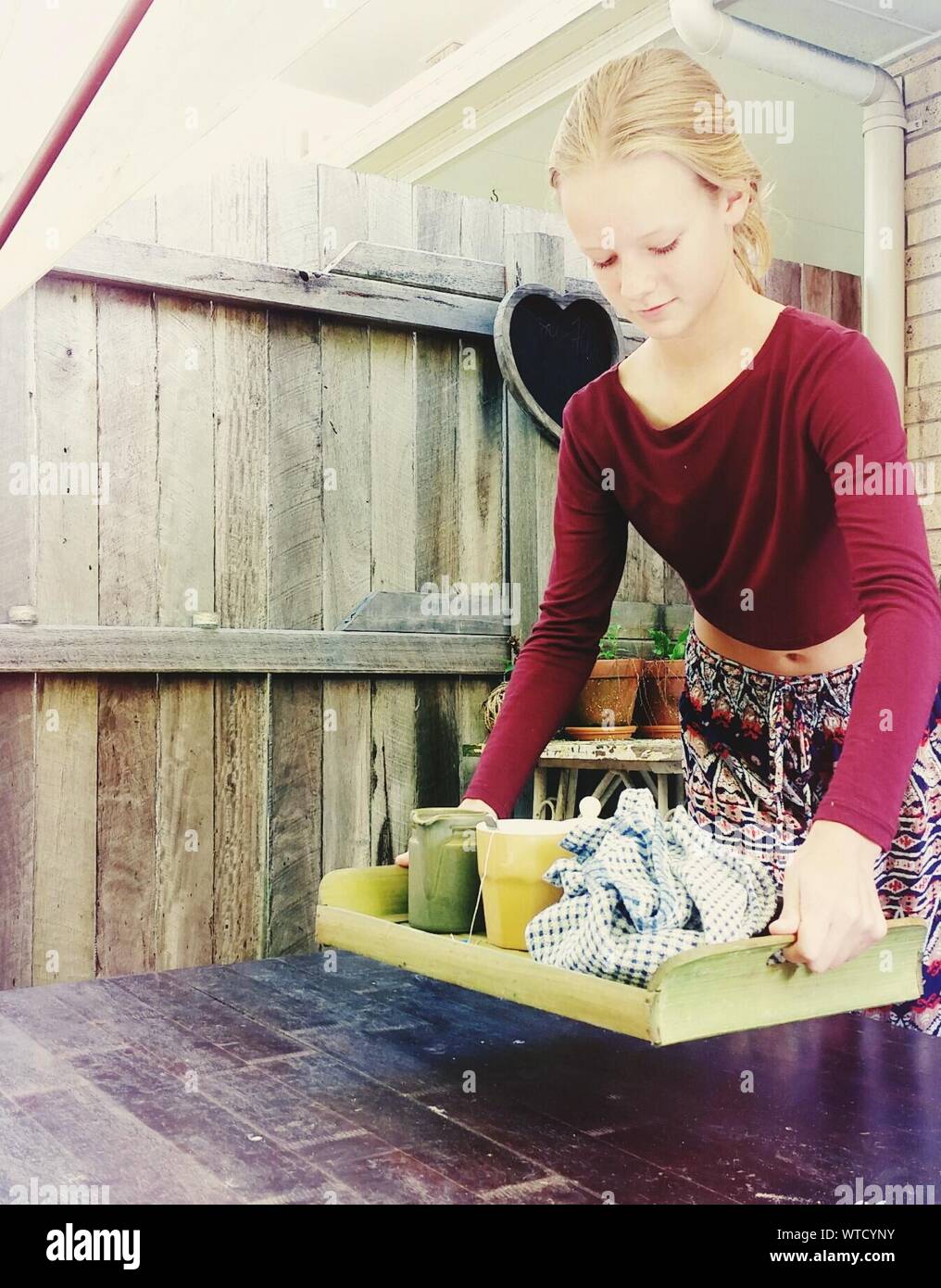 Teenage Girl Placing Tray On Table Stock Photo - Alamy