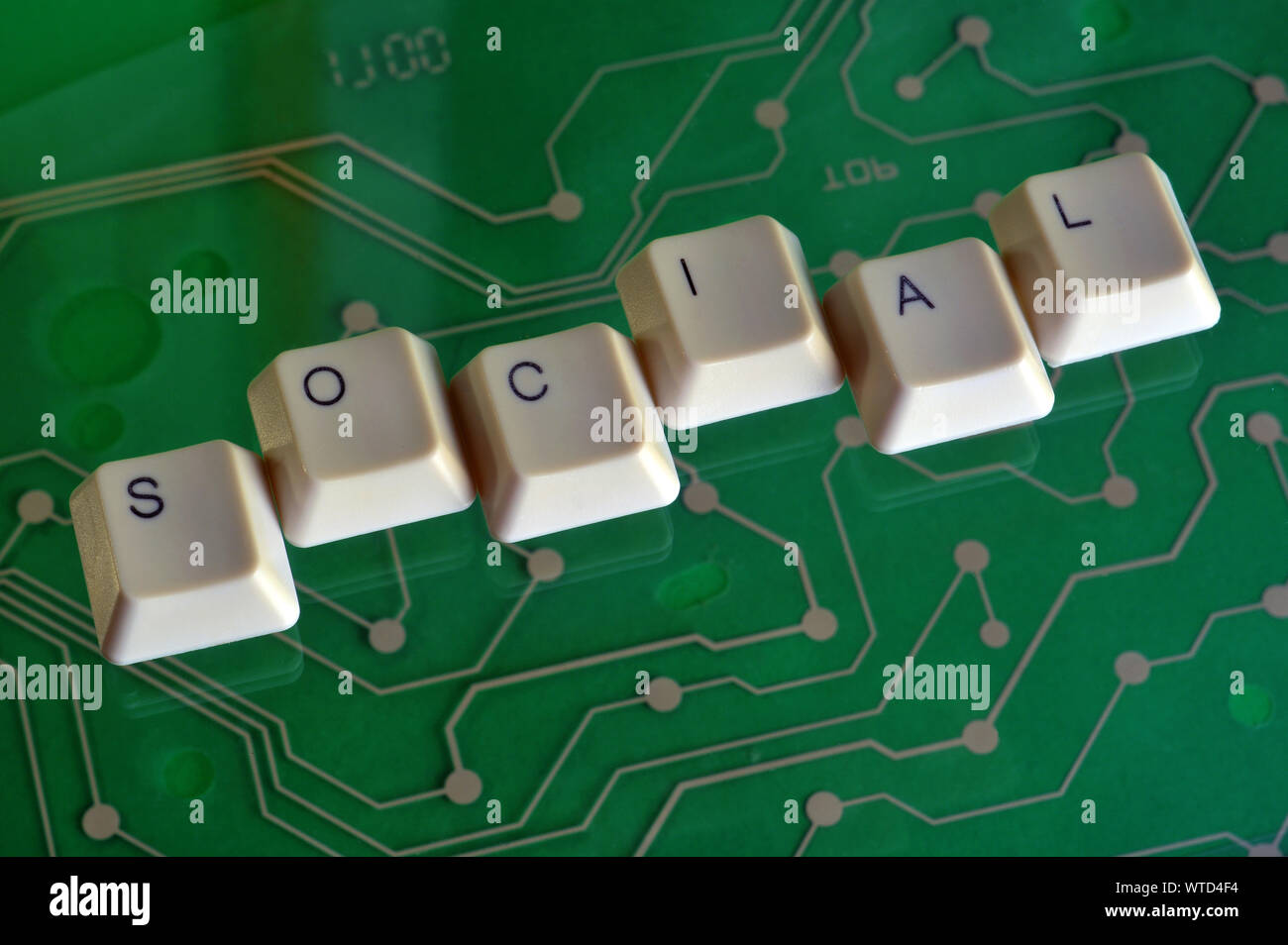 Keyboard keys form the word SOCIAL on green electric circuit in the ...