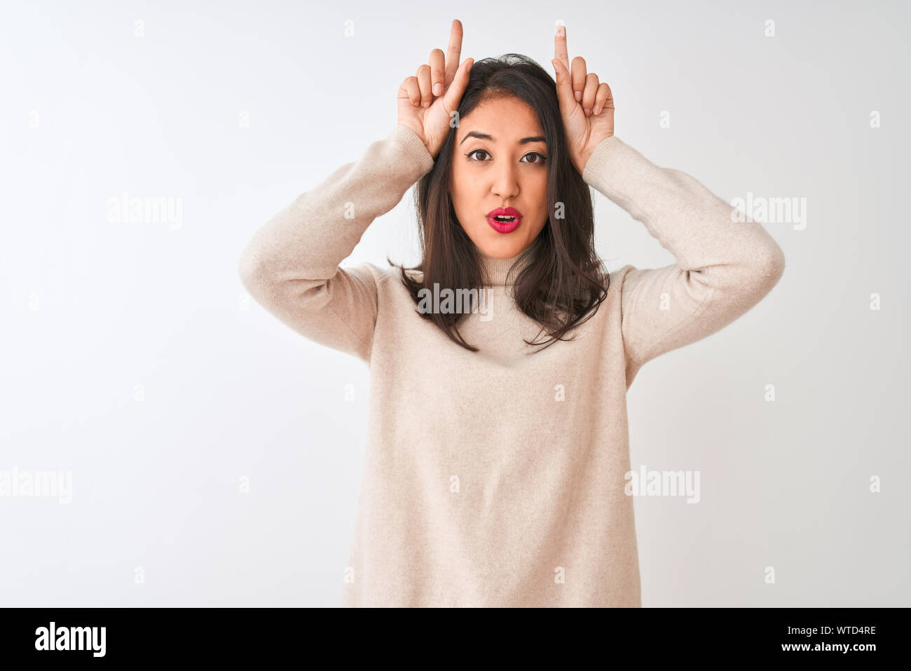Beautiful chinese woman wearing turtleneck sweater standing over ...