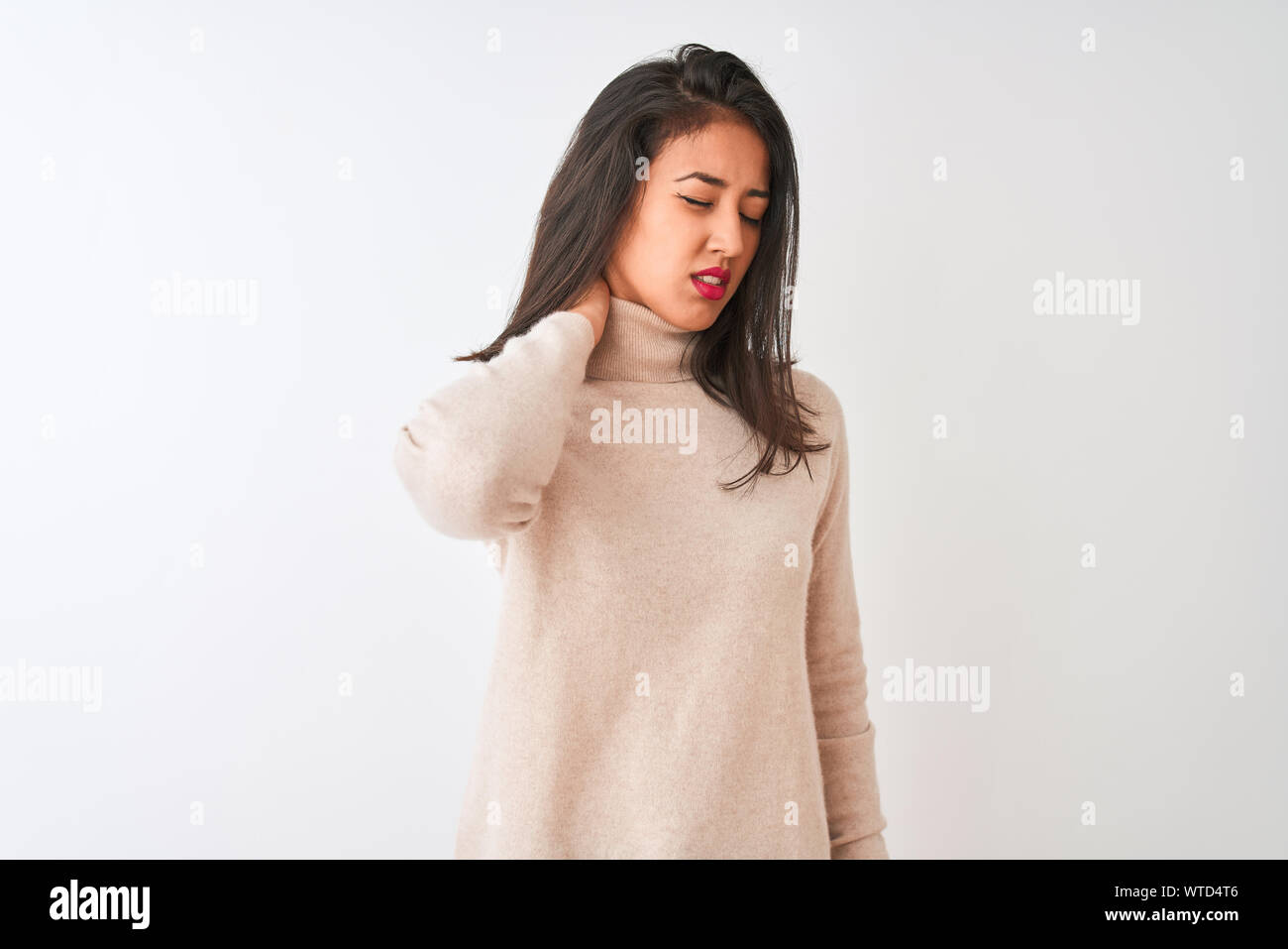 Beautiful chinese woman wearing turtleneck sweater standing over ...