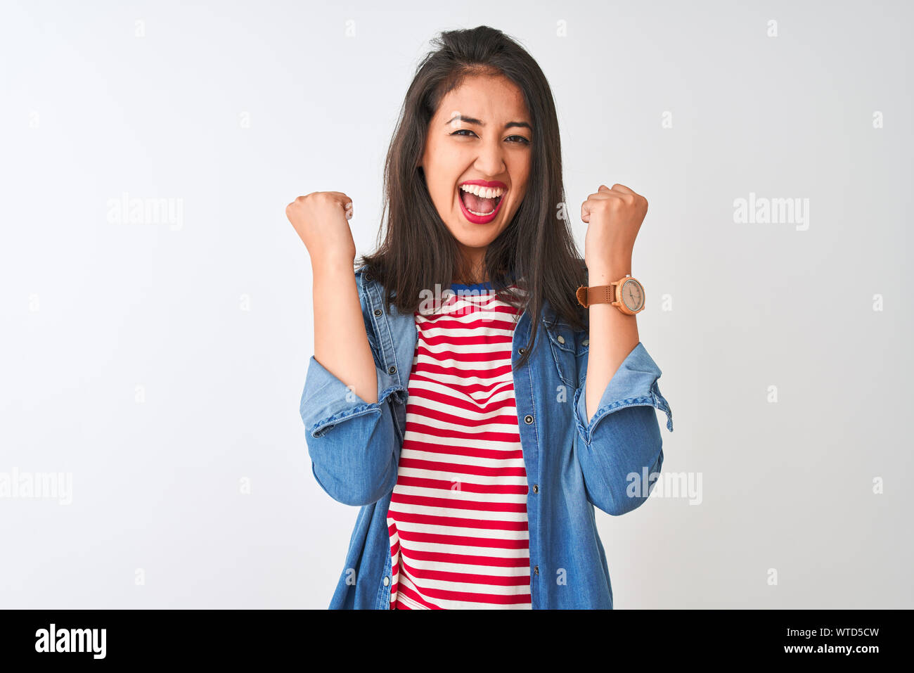 Young chinese woman wearing striped t-shirt and denim shirt over ...