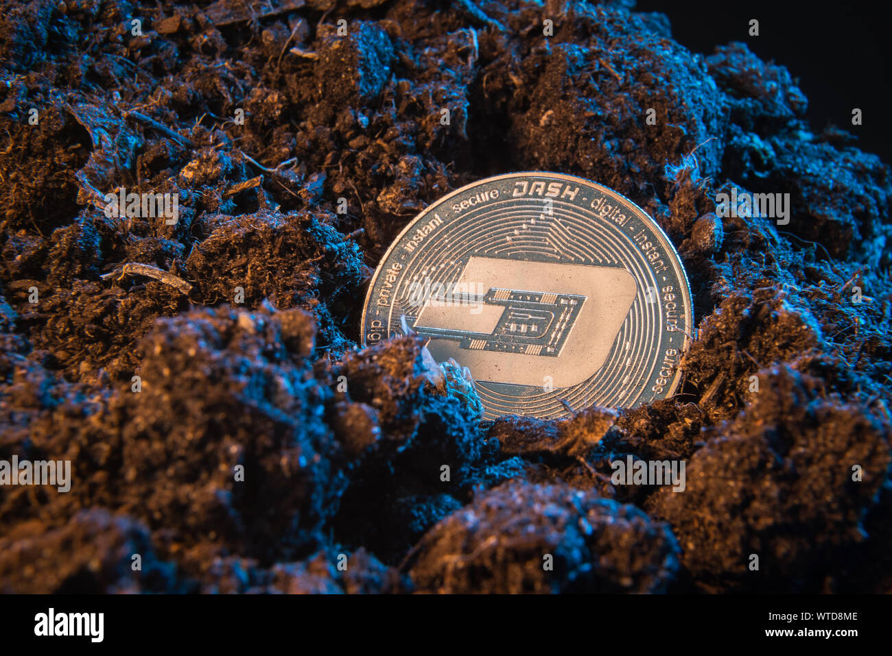 Mining crypto currency - Dash coin. Online money coin in the dirt ...