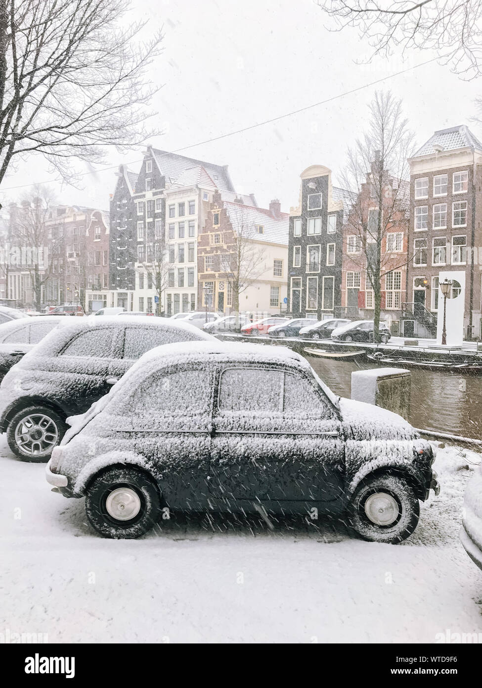Snowy little car on the bridge in the city center Amsterdam Netherlands ...