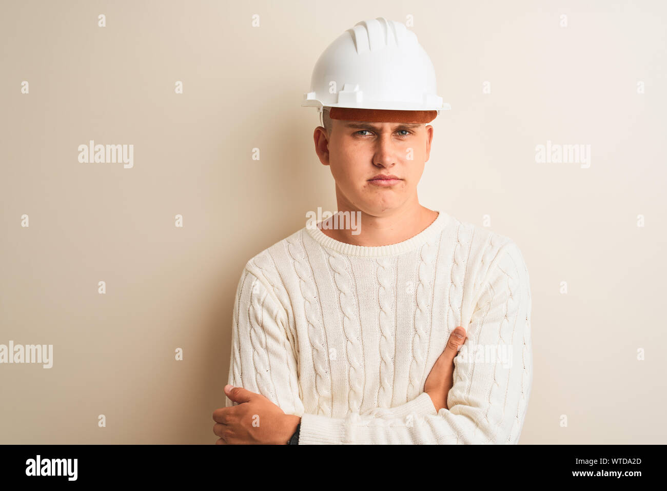 Handsome architect man wearing security helmet standing over isolated ...