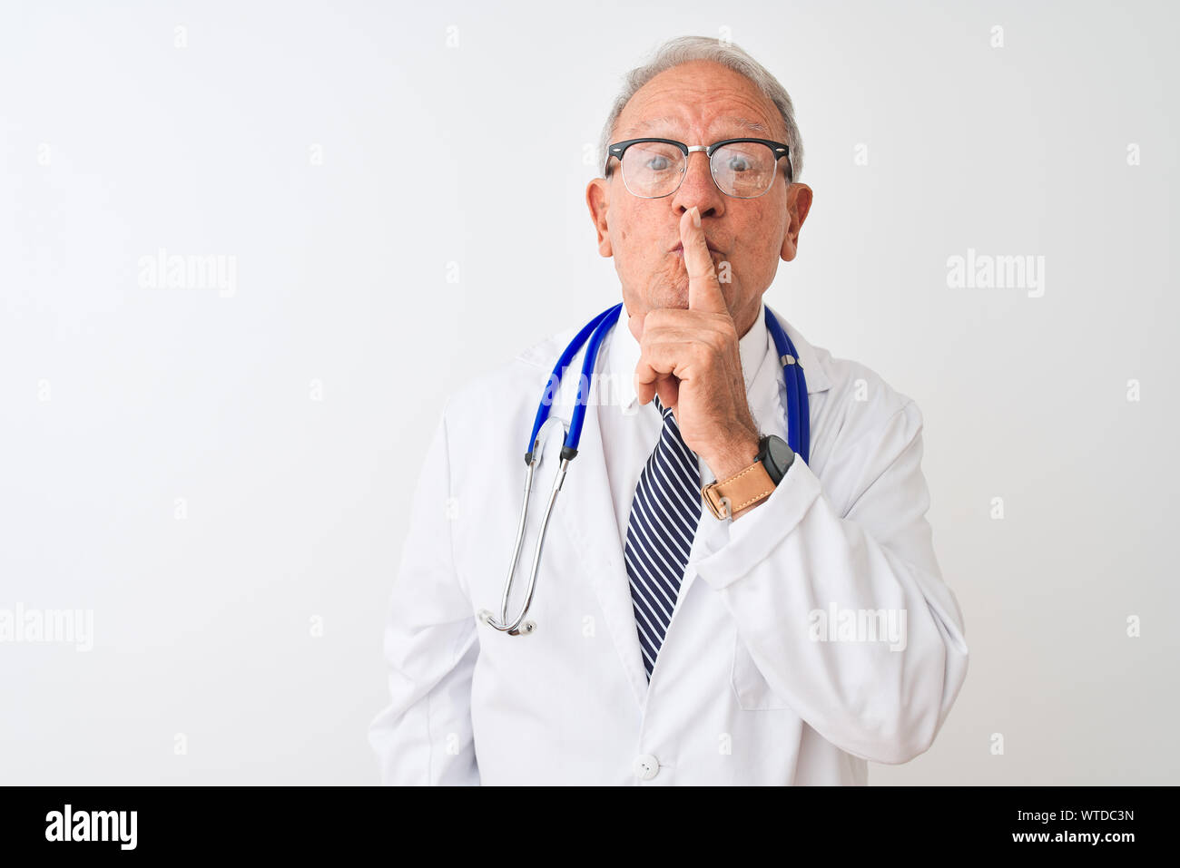 Senior grey-haired doctor man wearing stethoscope standing over ...