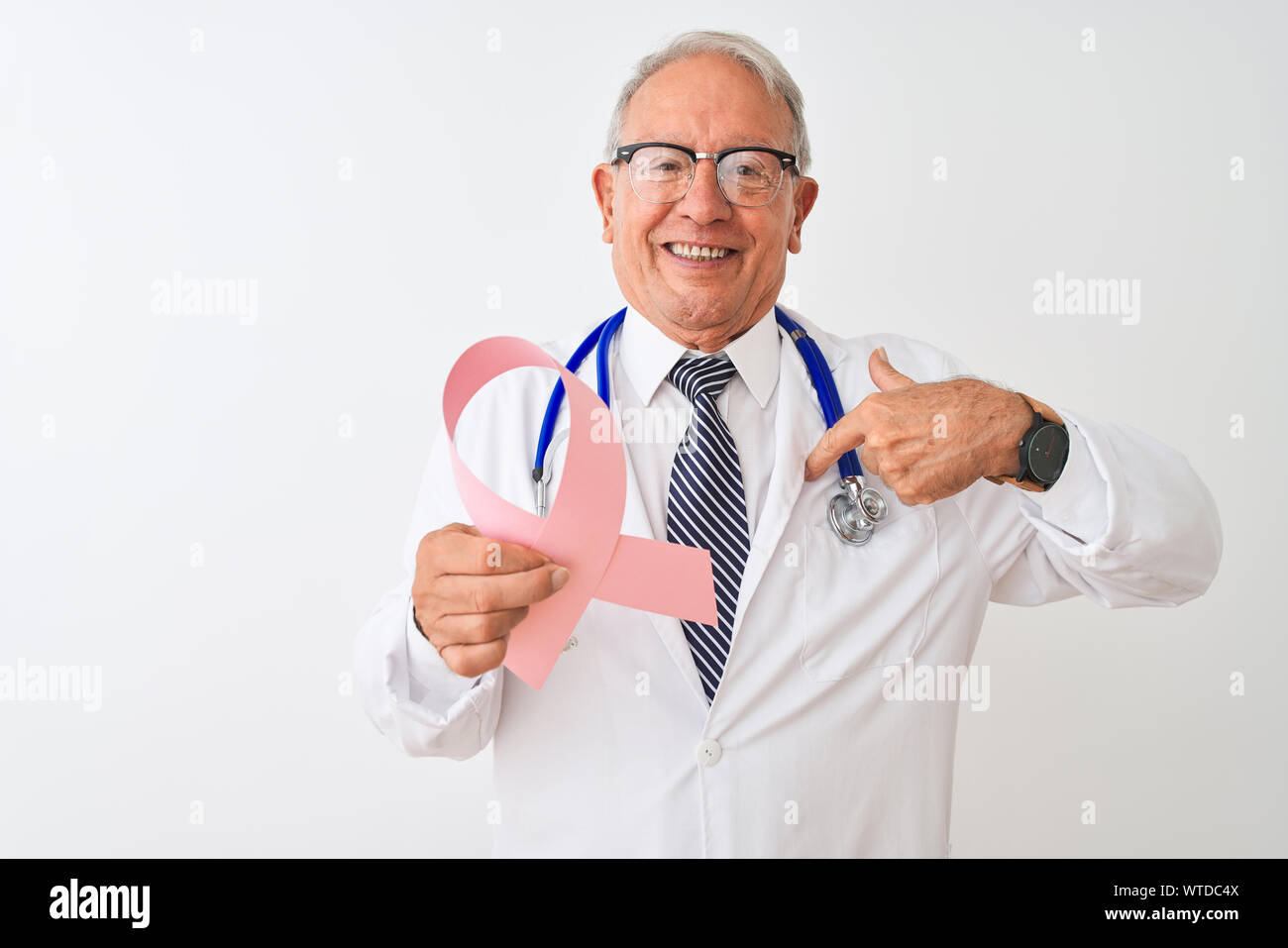 Senior grey-haired doctor man holding cancer ribbon over isolated white ...