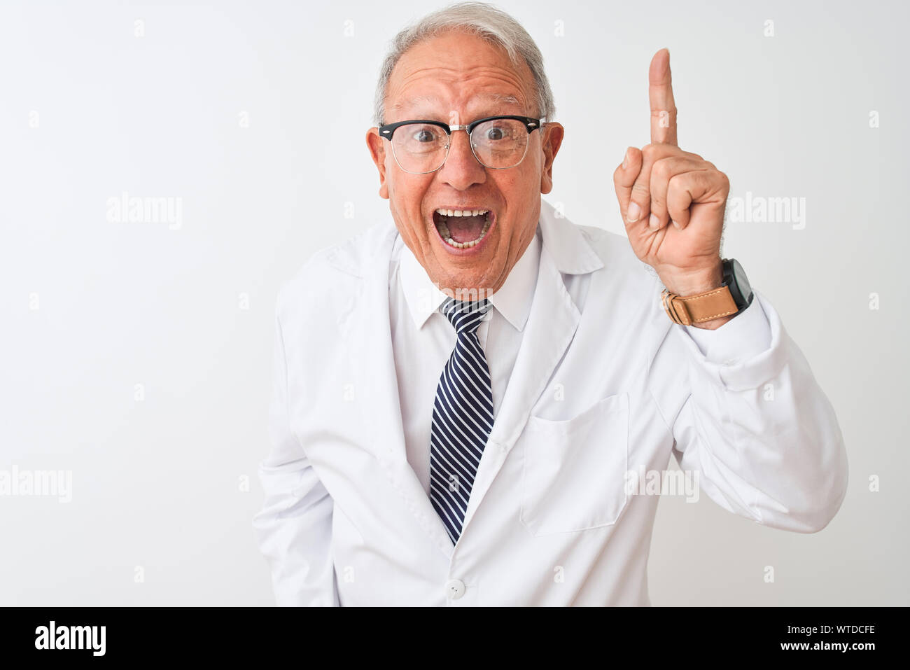 Senior grey-haired scientist man wearing coat standing over isolated ...