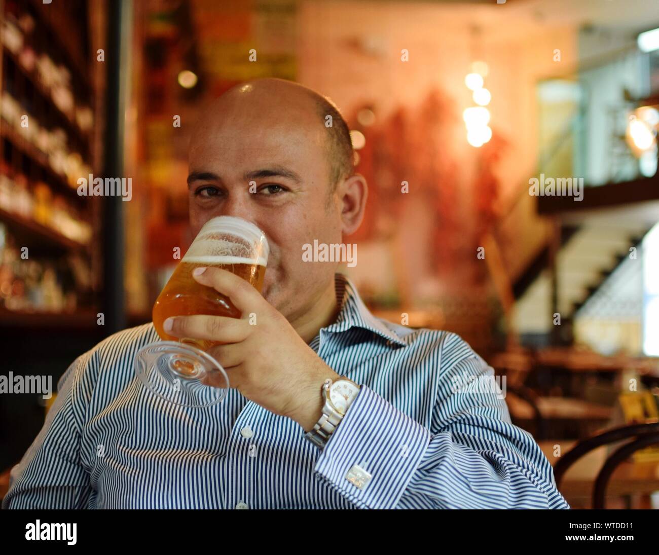 Man looking at beer in glass hi-res stock photography and images - Alamy