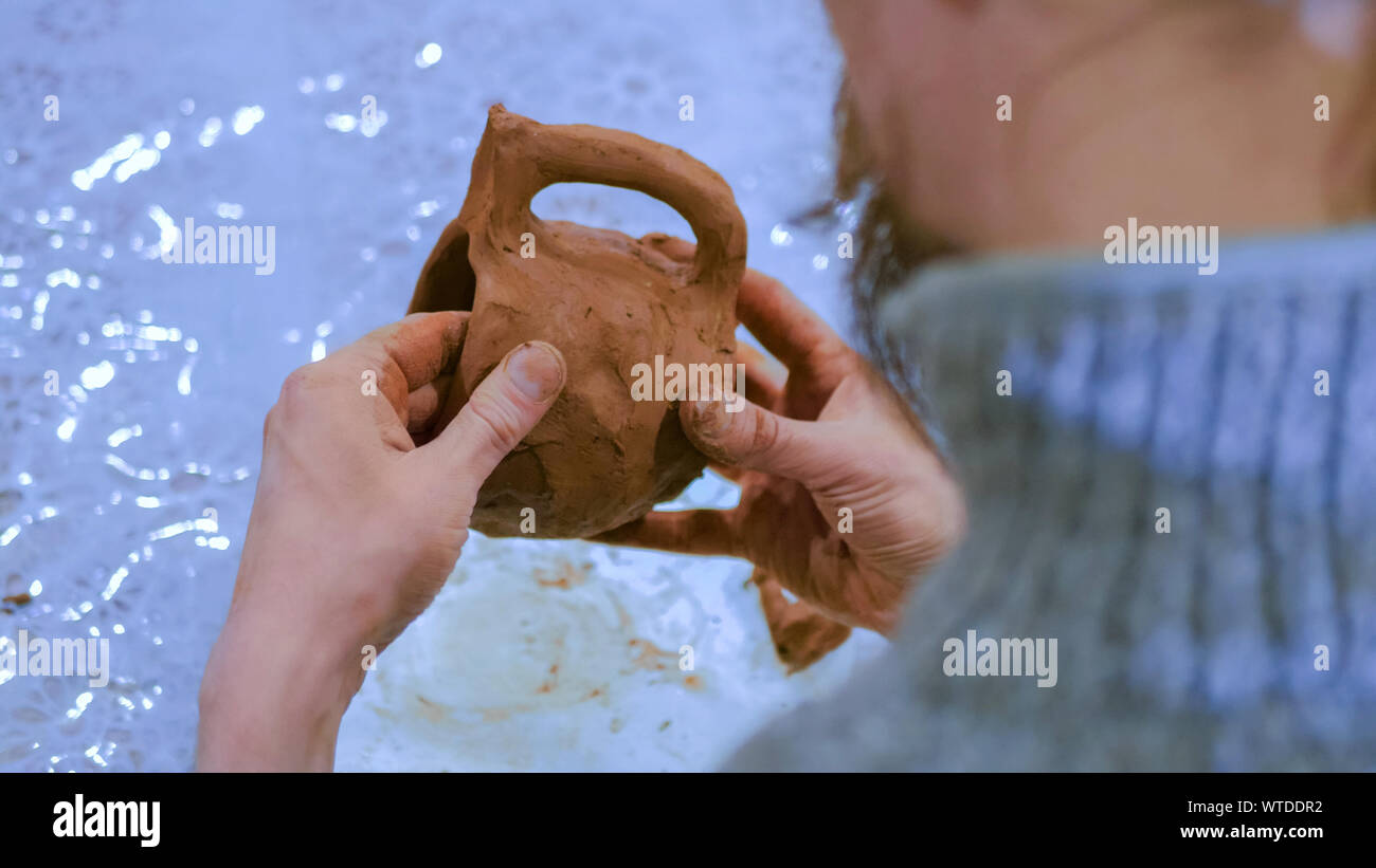 Professional male potter making mug in pottery workshop Stock Photo - Alamy