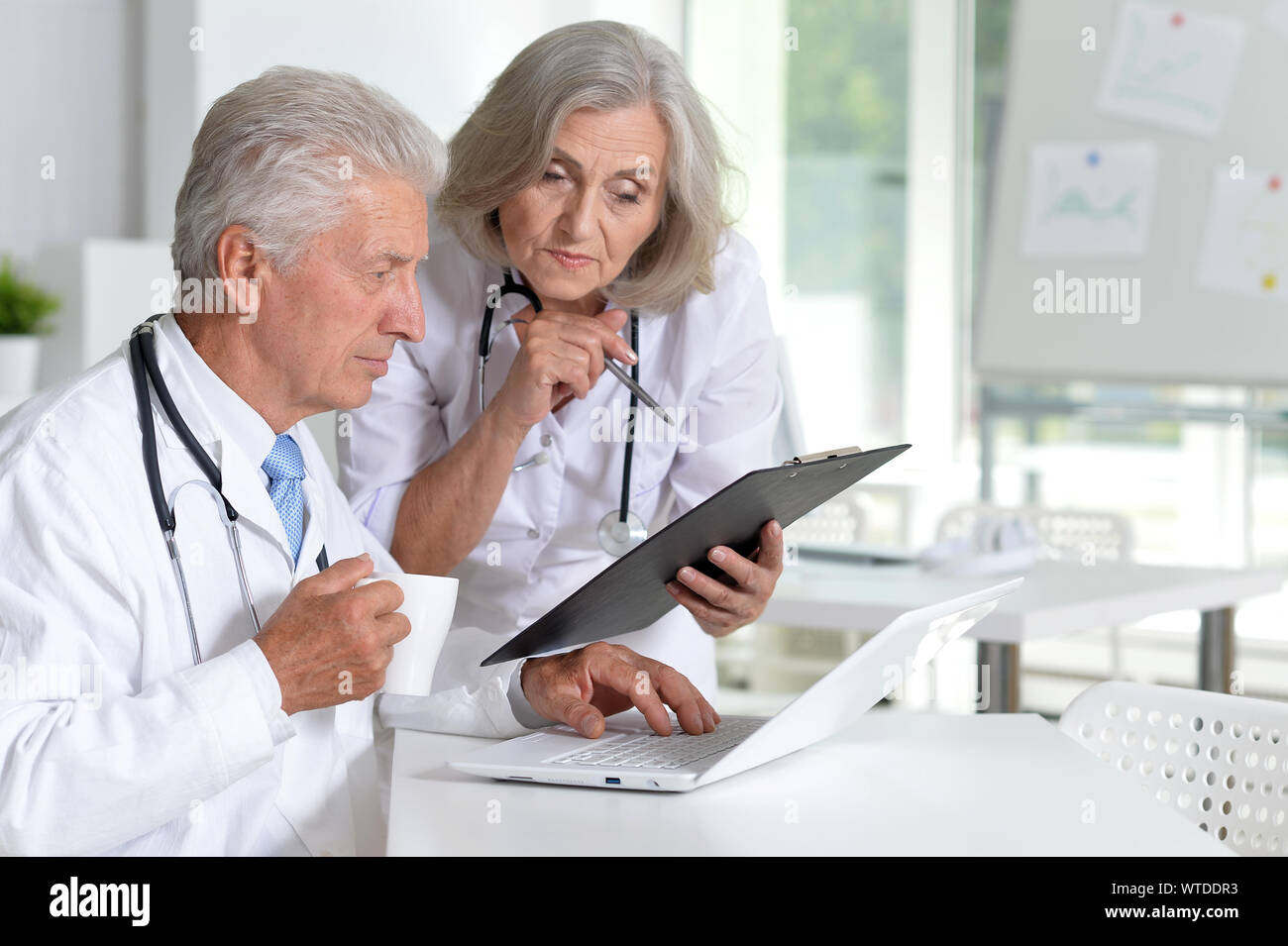 Professional doctors working in cabinet in hospital Stock Photo - Alamy