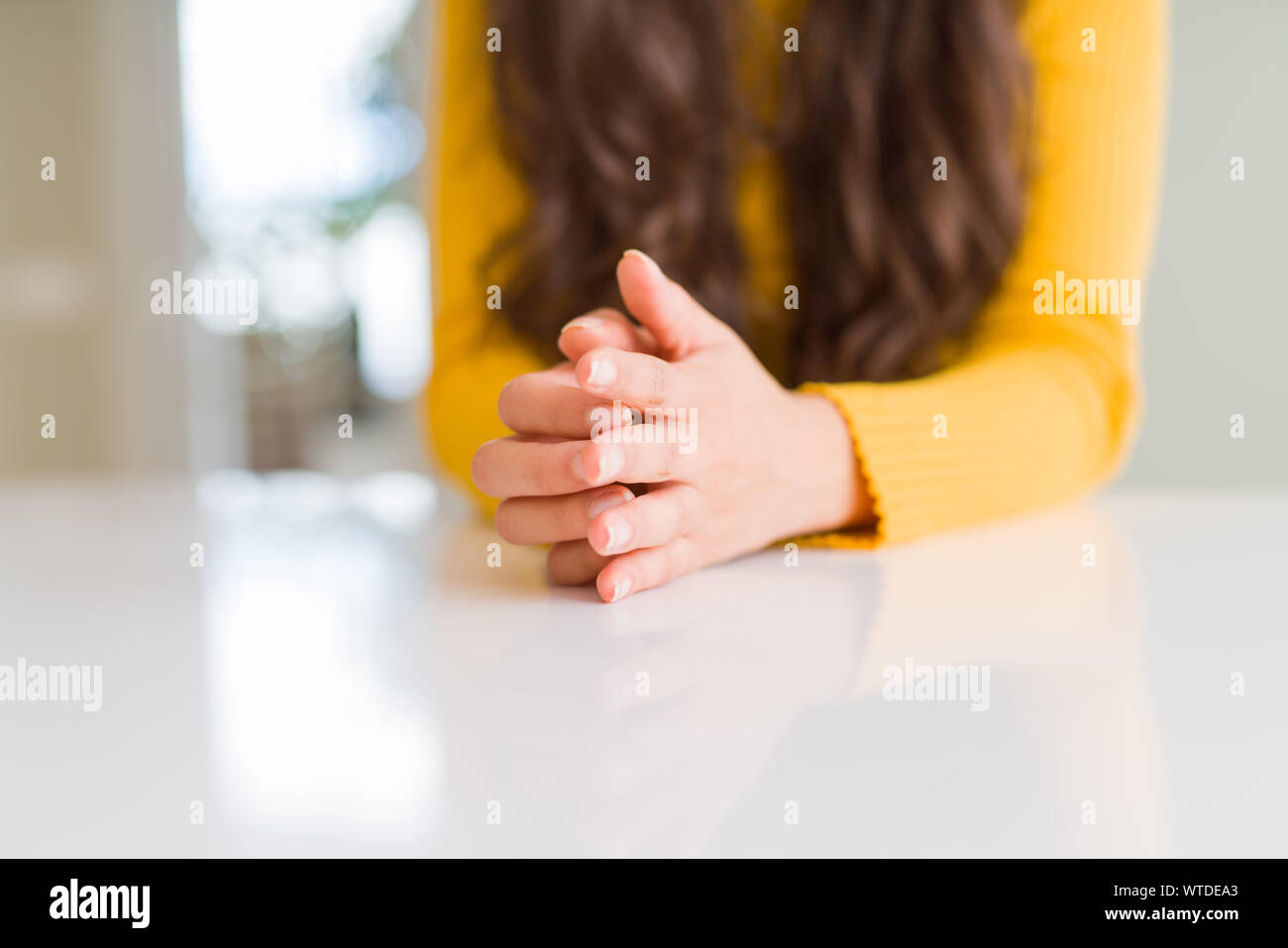 Close up of woman hands over white table Stock Photo - Alamy