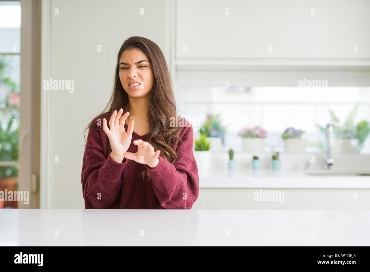 Young beautiful woman at home disgusted expression, displeased and ...