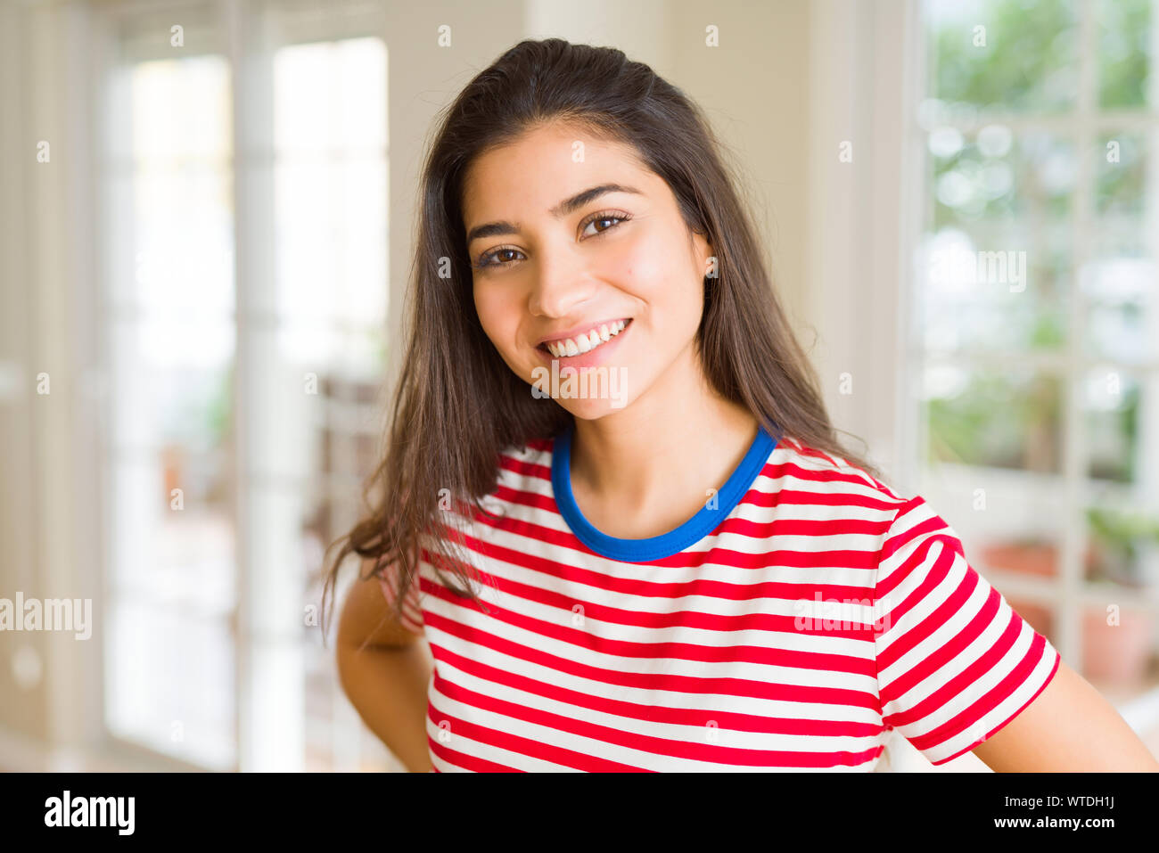 Beautiful brunette woman smiling cheerful, looking happy and positive ...