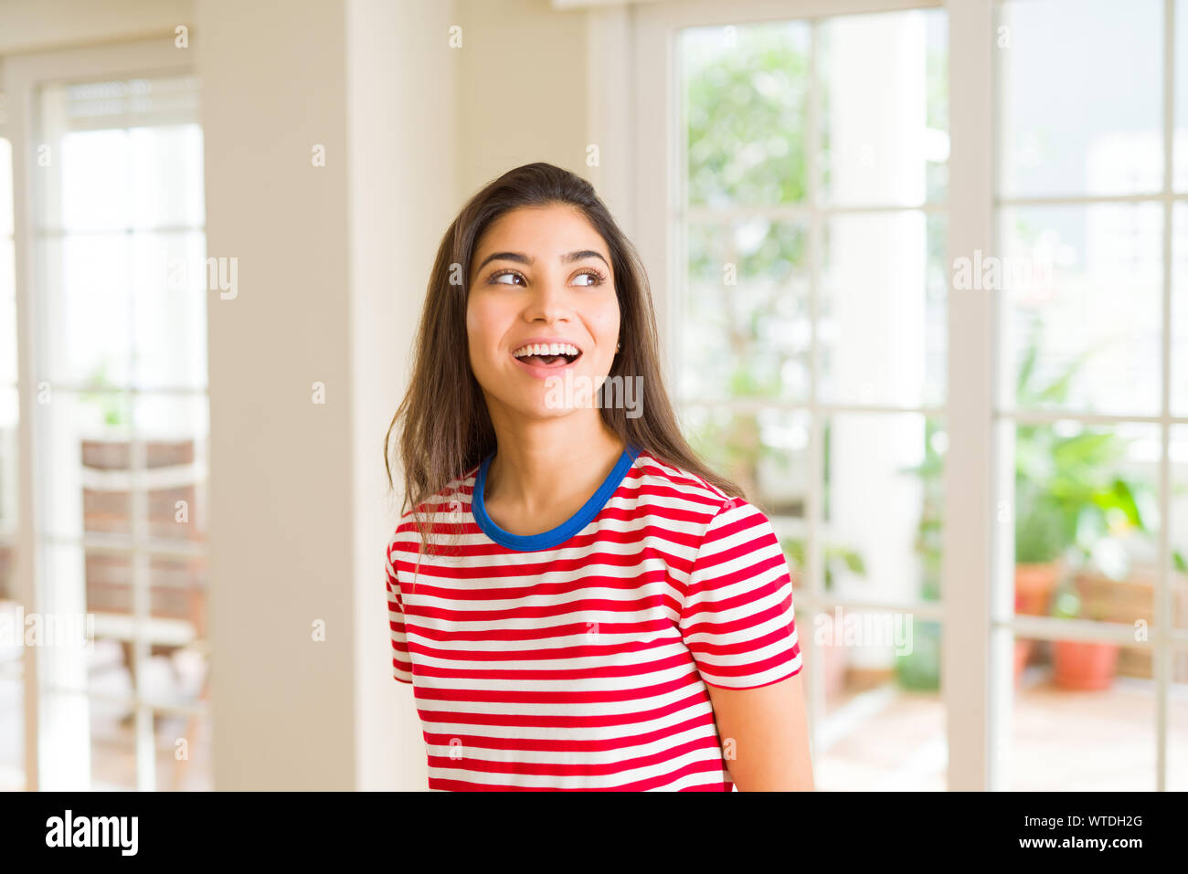 Beautiful brunette woman smiling cheerful, looking happy and positive ...