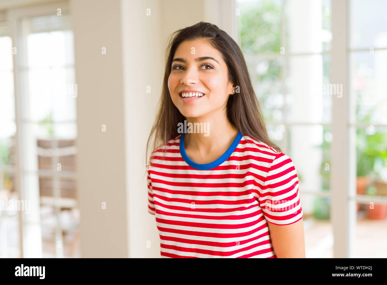 Beautiful brunette woman smiling cheerful, looking happy and positive ...