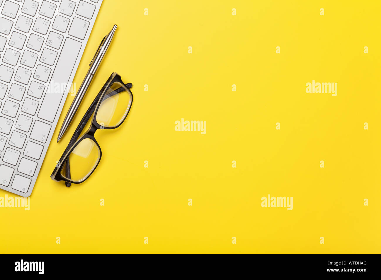 Office yellow workplace backdrop with supplies and computer. Flat lay ...