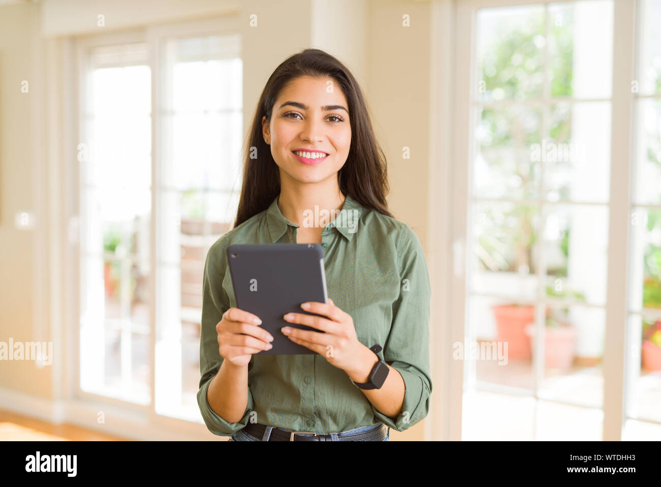 Beautiful young woman working using touchpad tablet Stock Photo - Alamy