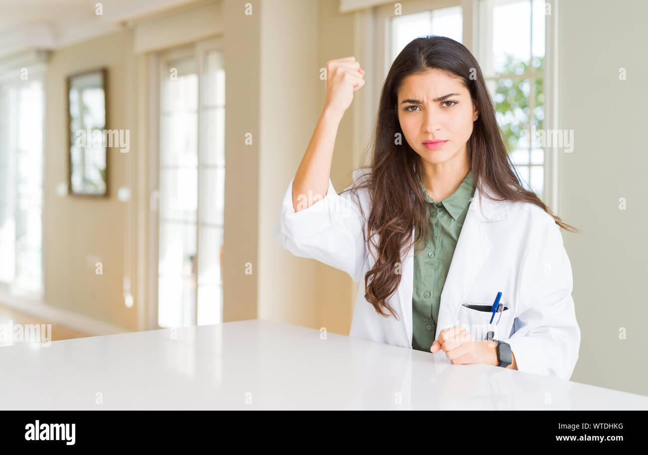 Young woman wearing medical coat at the clinic as therapist or doctor ...