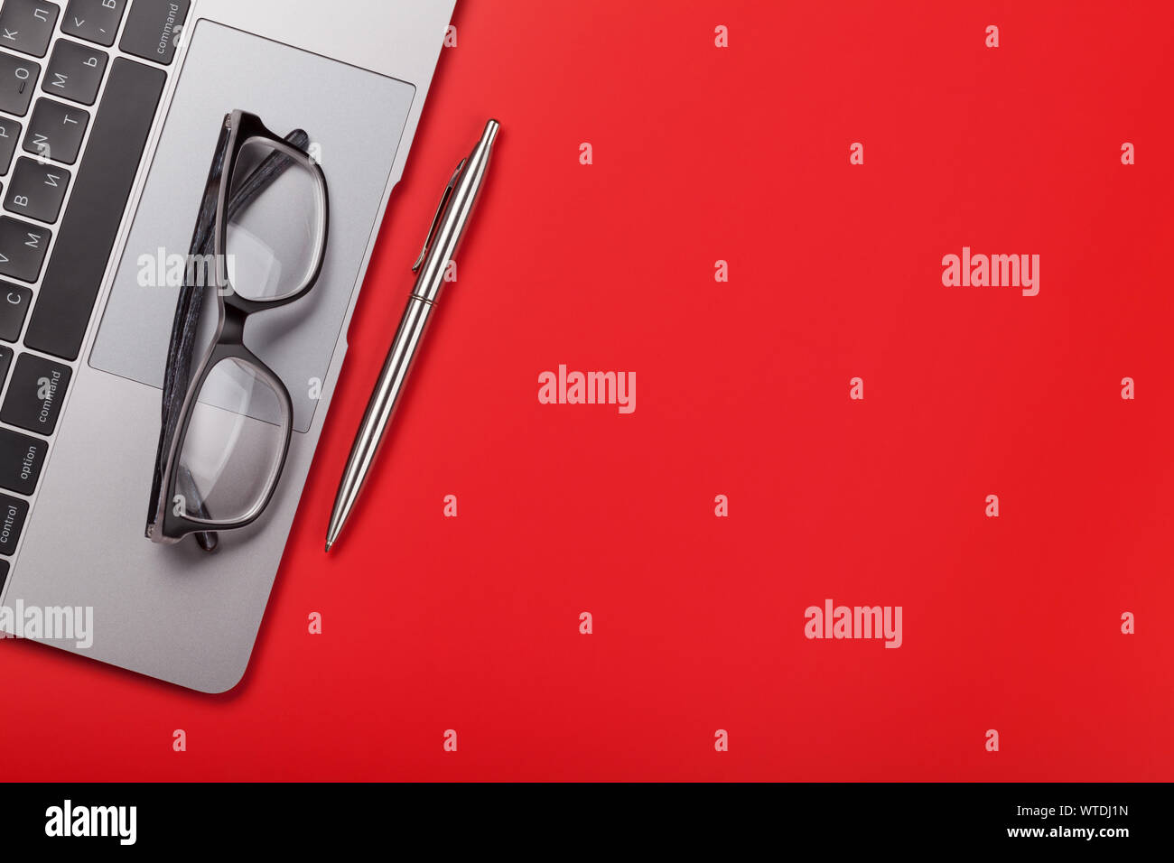 Office red workplace backdrop with glasses and computer. Flat lay. Top ...