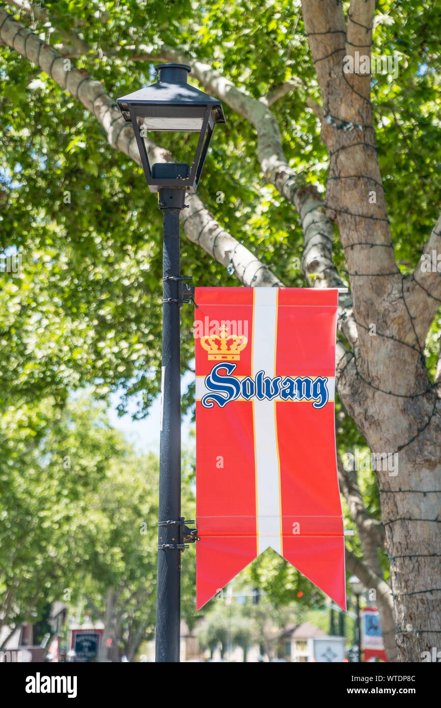 The Solvang Banner with the city's insignia and flag hanging from a ...