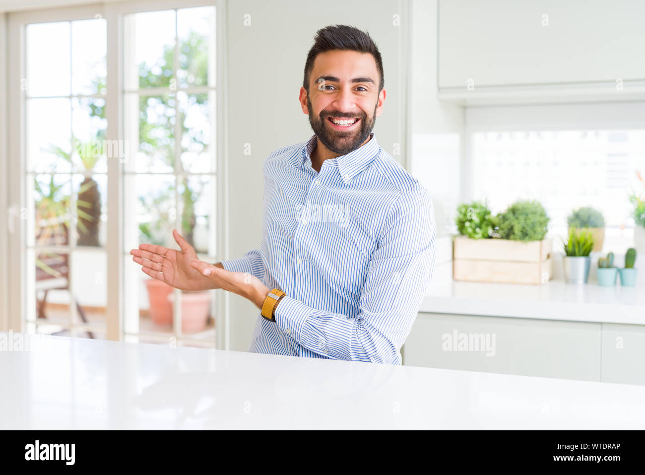 Handsome hispanic business man Inviting to enter smiling natural with ...