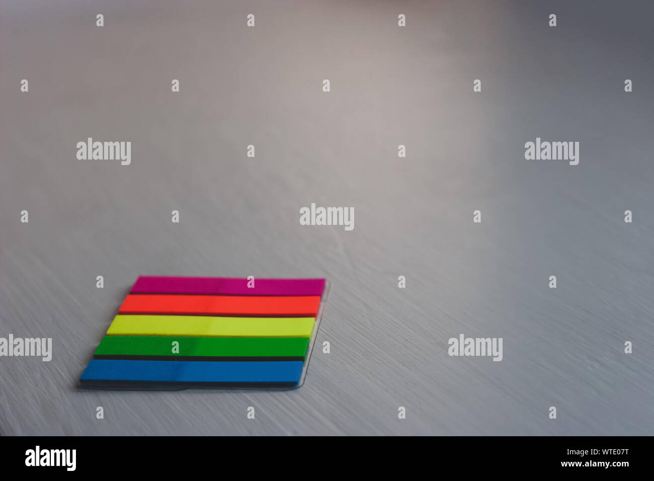 A set of colored bookmarks lies on a light colored surface from the ...