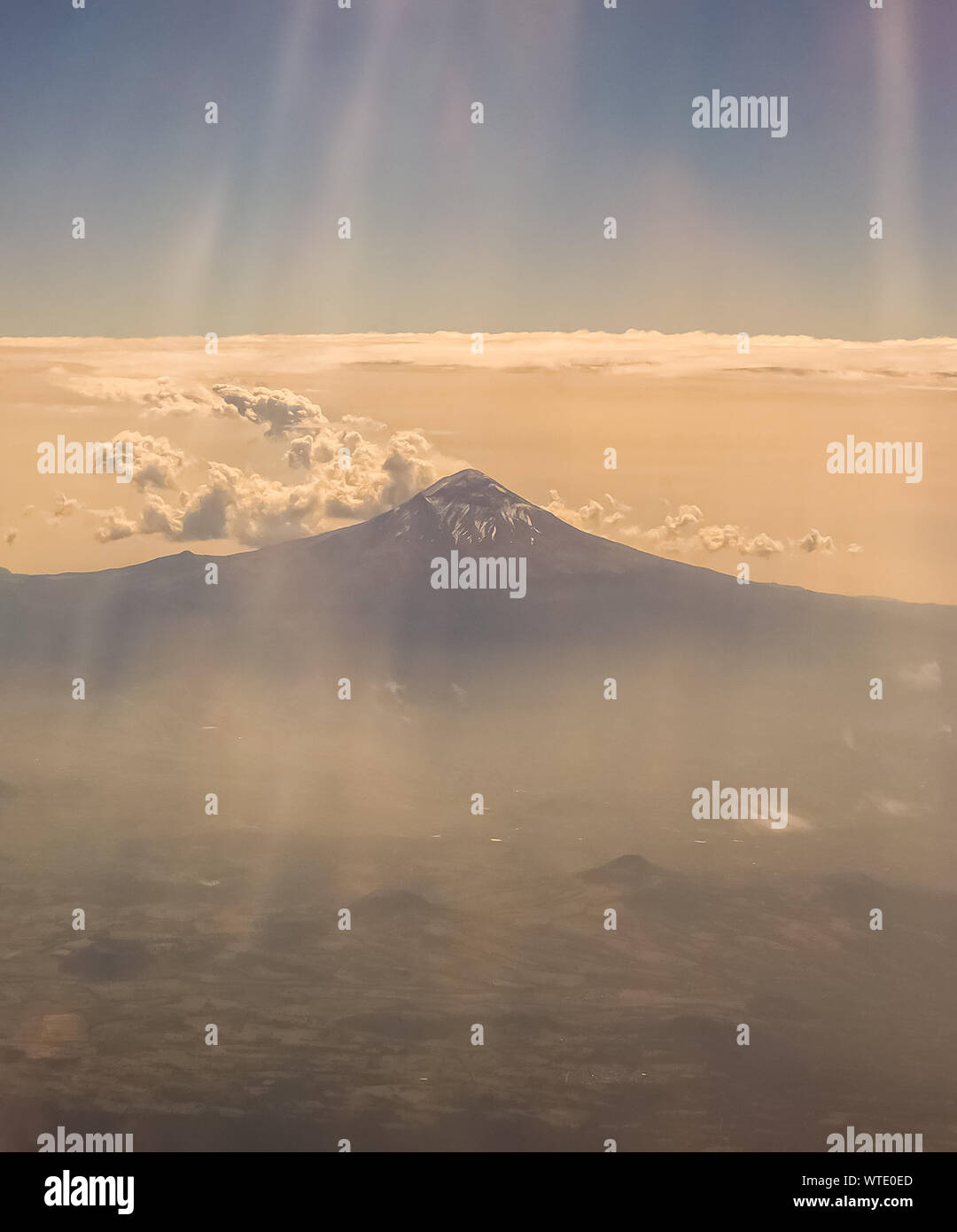 view from the plane of a volcano with clouds in mexico city Stock Photo ...
