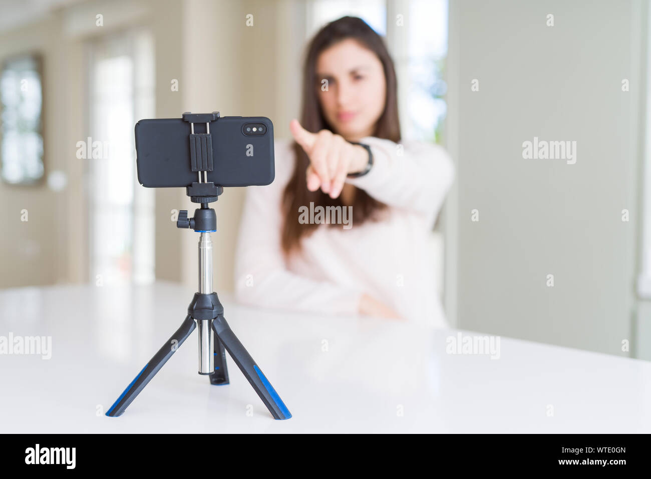 Beautiful young woman recording selfie video with smartphone webcam ...