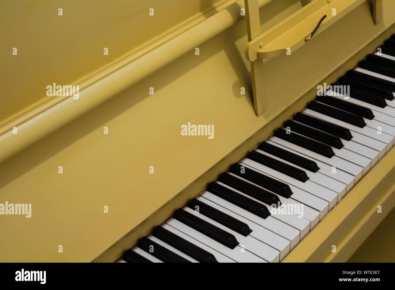 Yellow piano shot from an angle Stock Photo - Alamy
