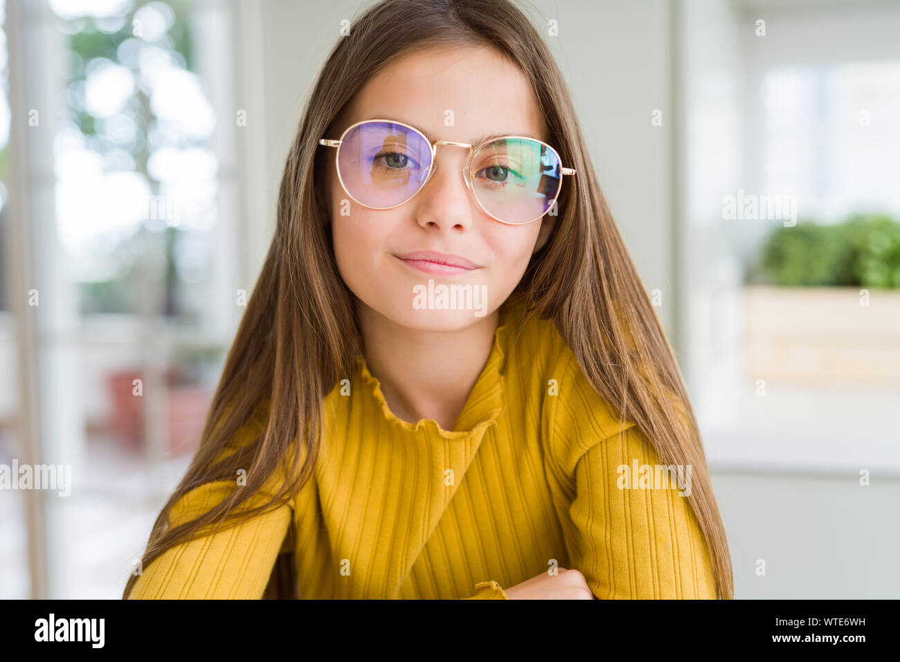 Beautiful young girl kid wearing glasses Relaxed with serious ...