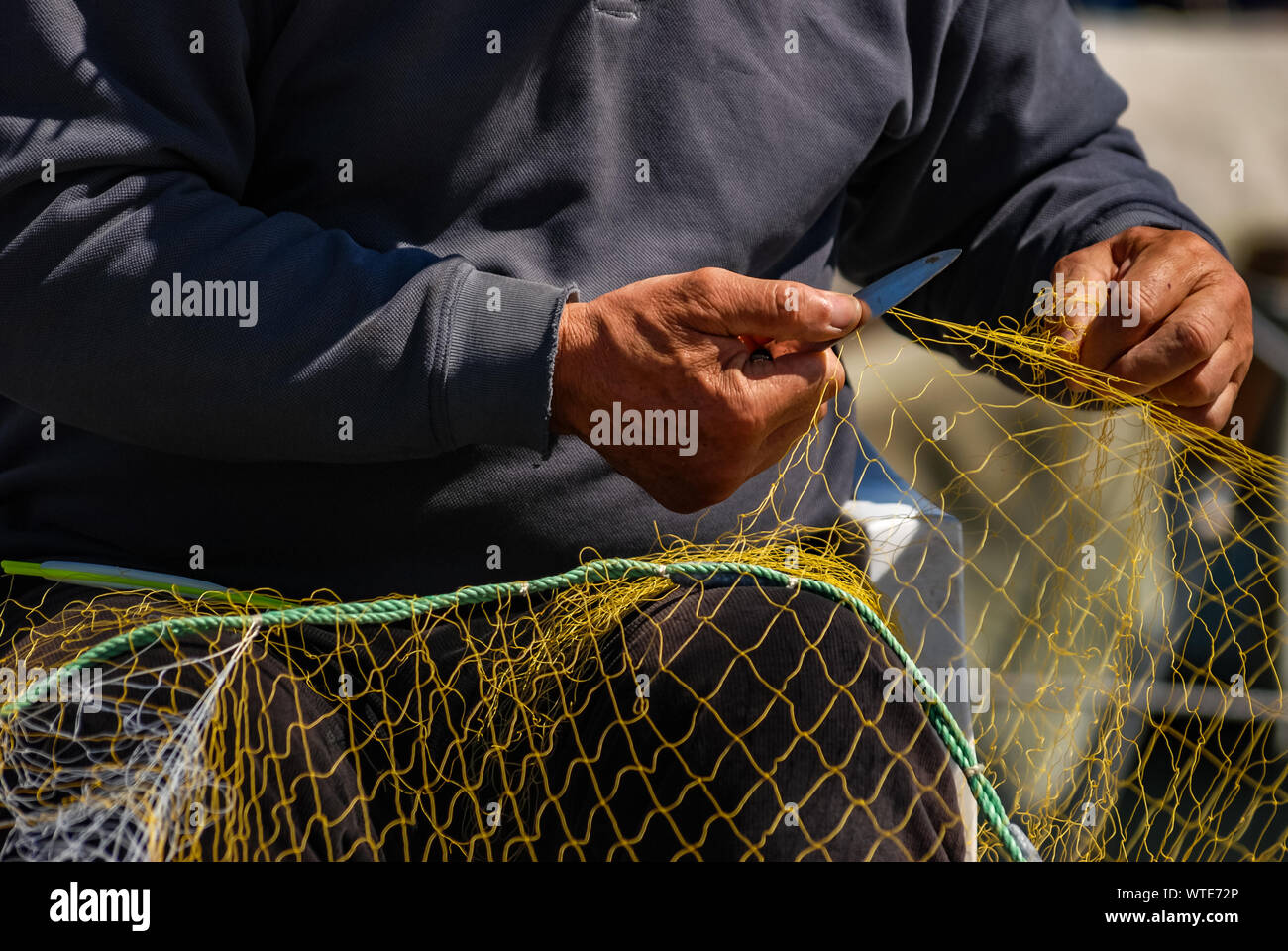 Fish net repair hi-res stock photography and images - Alamy