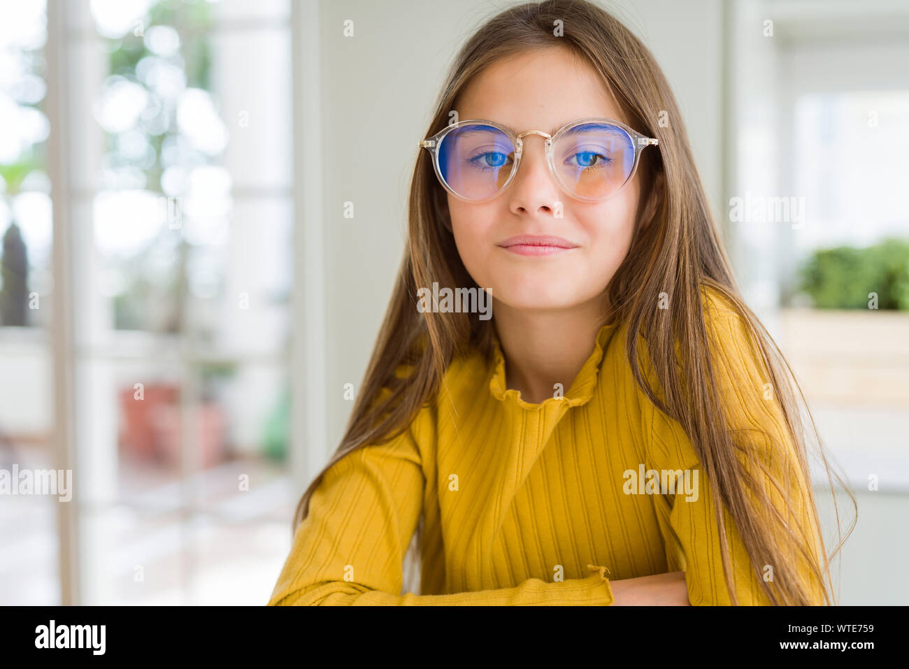 Beautiful young girl kid wearing glasses Relaxed with serious ...