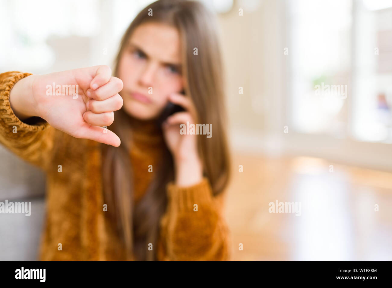 Beautiful young girl kid having a conversation talking on smartphone ...